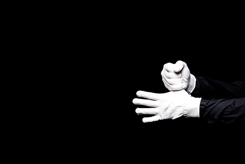 유토이미지 | cropped image of mime hiding thumb isolated on black