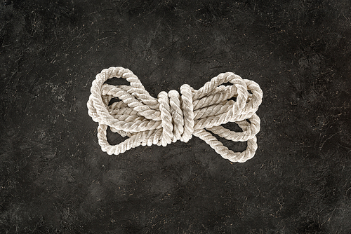 유토이미지 | top view of tied white nautical rope on dark concrete tabletop