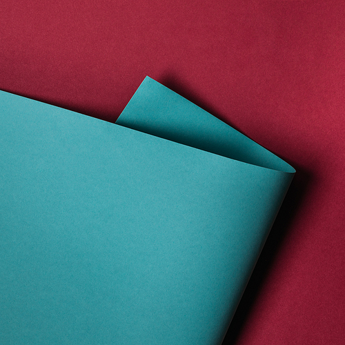 유토이미지 | close-up view of turquoise paper sheet on maroon background