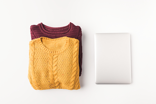 유토이미지 | top view of warm knitted sweaters and laptop, isolated on white
