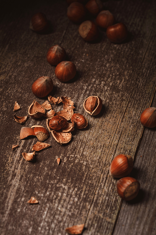 close up view of shelled hazelnuts and husk on wooden tabletop | 유토이미지 ...
