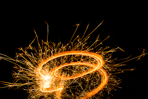 close-up view of festive burning new year sparkler on black background ...