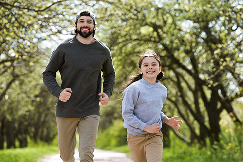 유토이미지 | smiling father and daughter running in park