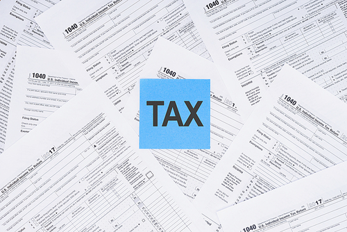 유토이미지 | top view of blue card with word 'tax' and documents on background