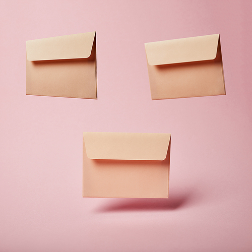 beige envelopes with copy space on pink and pastel background | 유토이미지 ...