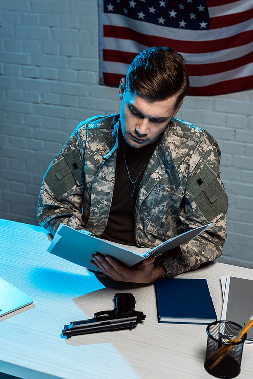 handsome soldier holding folder while sitting in modern office | 유토이미지 ...