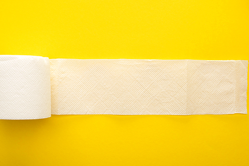 유토이미지 | top view of unrolled white toilet paper on yellow background