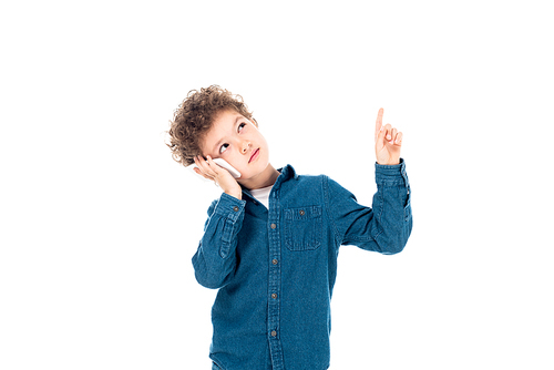 유토이미지 | pensive curly kid in denim shirt talking on smartphone and ...