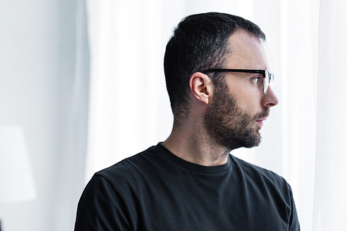 handsome pensive man in glasses looking out window at home | 유토이미지 | 상세 ...