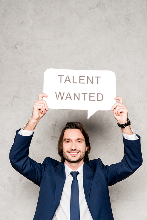 cheerful recruiter holding speech bubble with talent wanted lettering ...