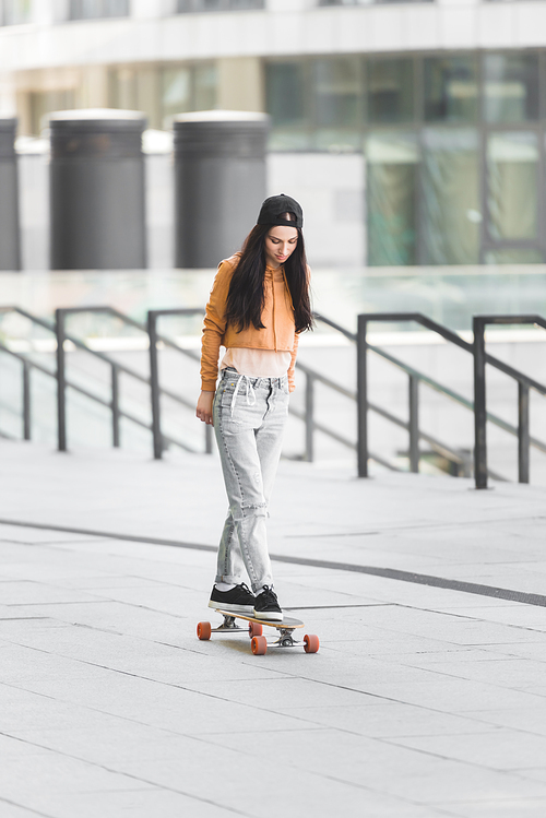 유토이미지 | beautiful brunette woman riding on skateboard in city