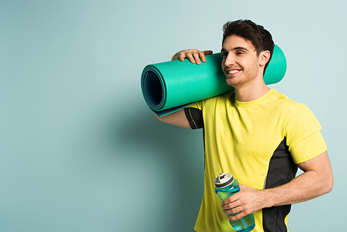 유토이미지 | smiling muscular sportsman in yellow t-shirt holding fitness ...