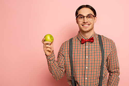 유토이미지 | cheerful male nerd in eyeglasses holding apple on pink
