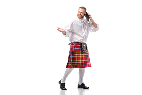 유토이미지 | smiling Scottish redhead man in red kilt talking on digital ...