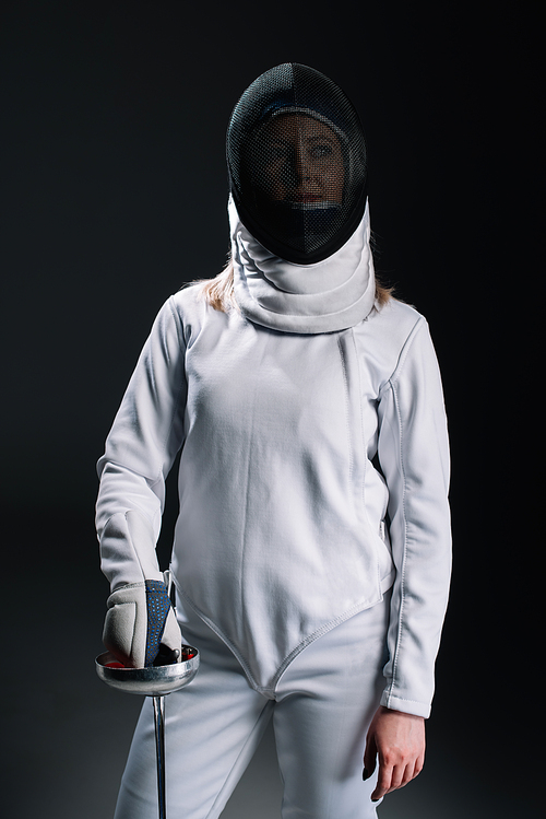 Fencer in fencing mask and suit holding rapier isolated on black | 유토 ...
