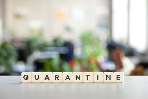 white cubes with quarantine lettering on white desk, covid-19 concept ...