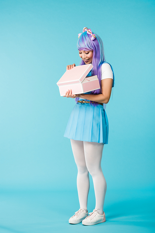 Full length view of anime girl in purple wig holding briefcase on blue ...