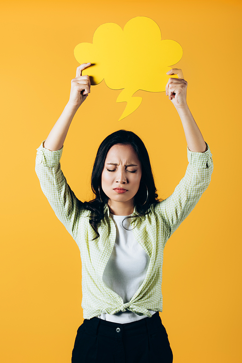 유토이미지 | upset asian girl holding cloud speech bubble, isolated on yellow