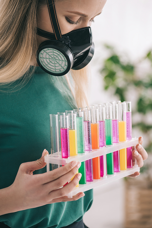 blonde girl in respiratory mask looking at colorful test tubes | 유토이미지 ...