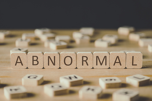 selective focus of abnormal lettering on cubes surrounded by blocks ...