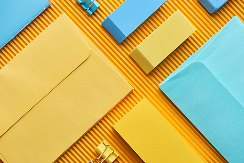 top view of sticky notes, envelopes and erasers on yellow | 유토이미지 | 상세 ...