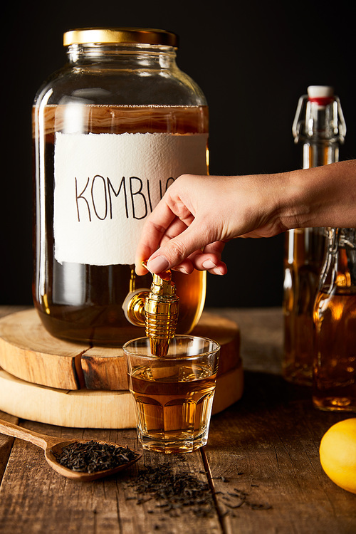유토이미지 | cropped view of woman pouring kombucha in glass from jar on ...
