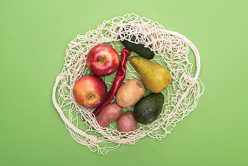 top view of vegetables and fruits in string bag isolated on green | 유토 ...