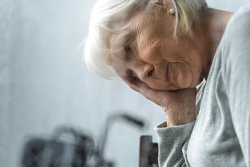 유토이미지 | sad senior woman with grey hair looking away