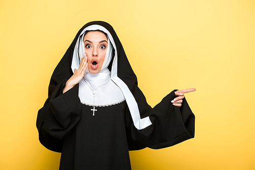 beautiful shocked nun pointing on yellow | 유토이미지 | 상세페이지 | 베이직샵 | 사진 ...