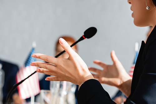 Cropped view of female politician gesturing, while speaking in ...