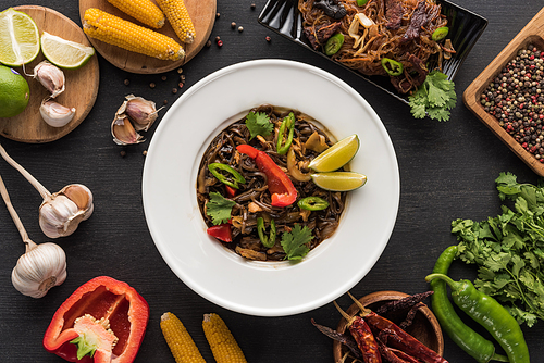 top view of tasty spicy meat thai noodles near chopsticks and fresh ...
