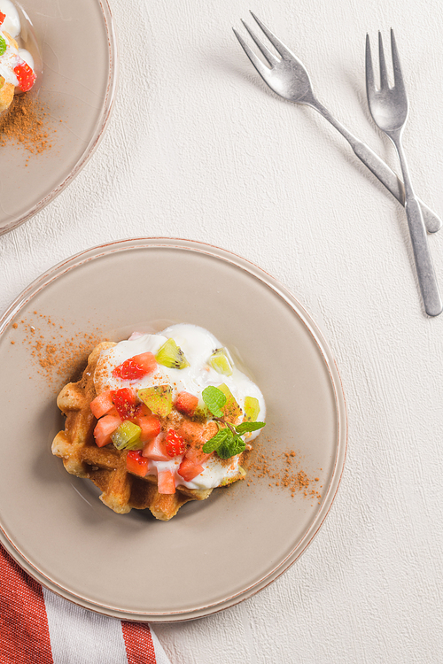 Fresh egg waffles dessert for breakfast with yogurt, strawberries and ...