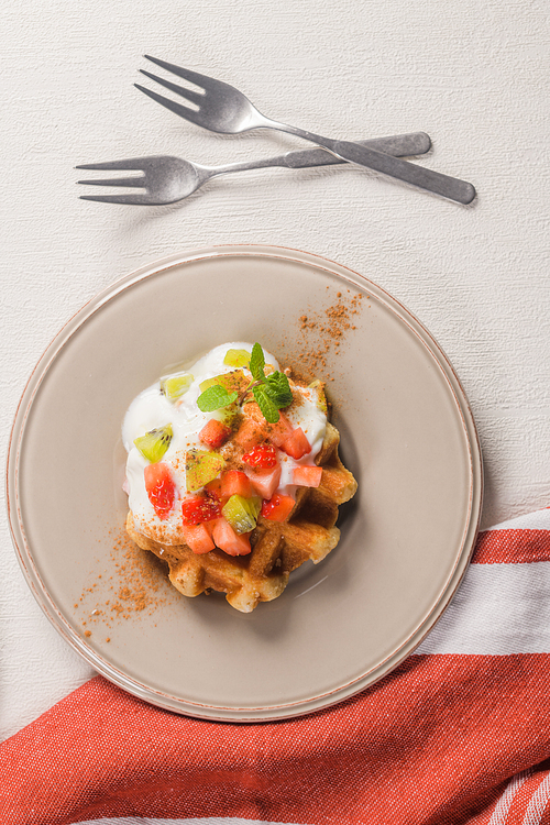 Fresh egg waffles dessert for breakfast with yogurt, strawberries and ...