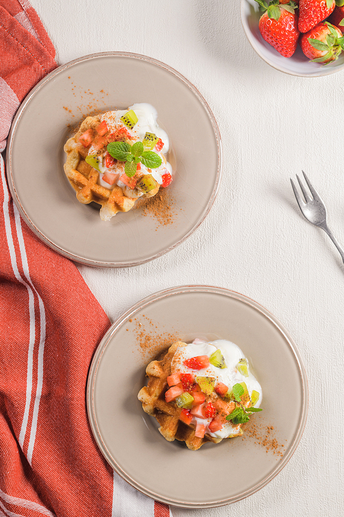 Fresh egg waffles dessert for breakfast with yogurt, strawberries and ...