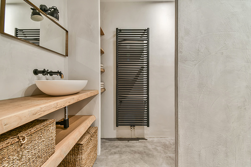Bathroom interior with a bowl-shaped sink and a rectangular mirror in a ...